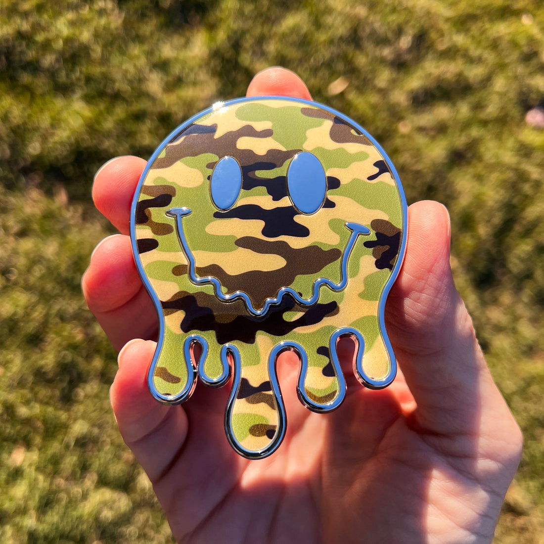 the MELTY SMILEY FACE BADGE