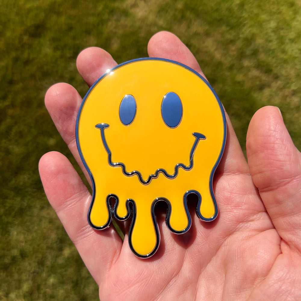 the MELTY SMILEY FACE BADGE